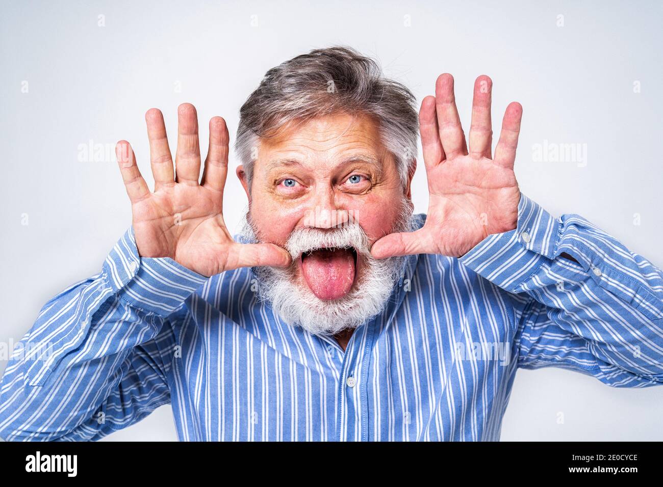 Eccentric senior man with funny expression portrait on background ...