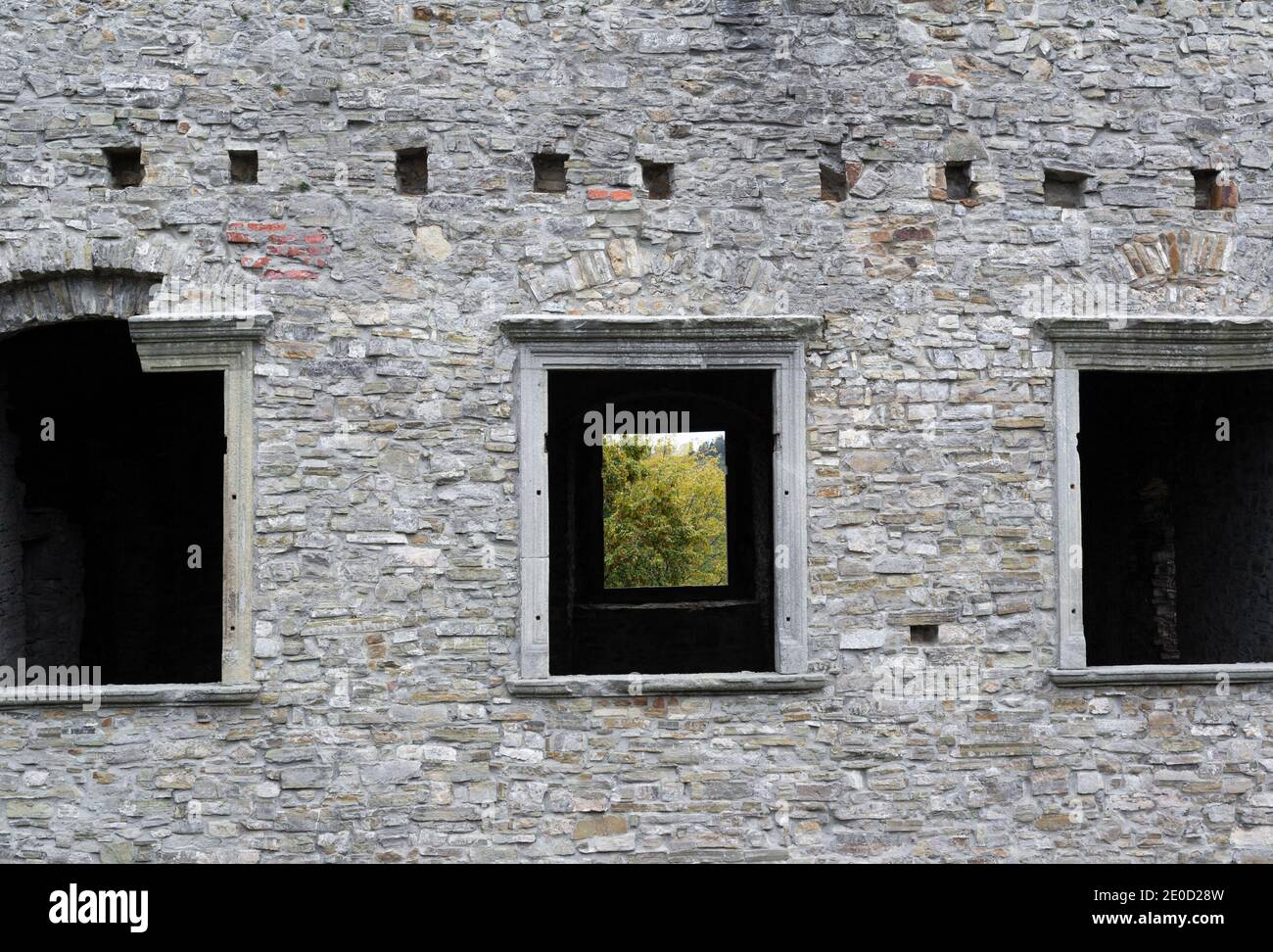 Old, historical and antique wall made of stone. Facade with windows and ...
