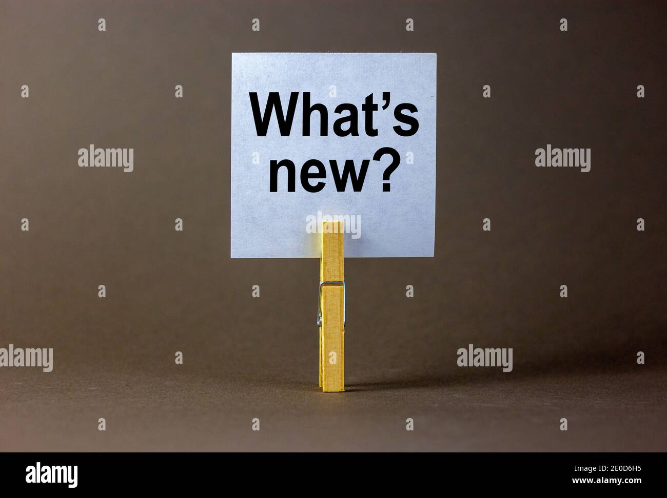 What is new symbol. White paper with words 'Whats New', clip on wood ...