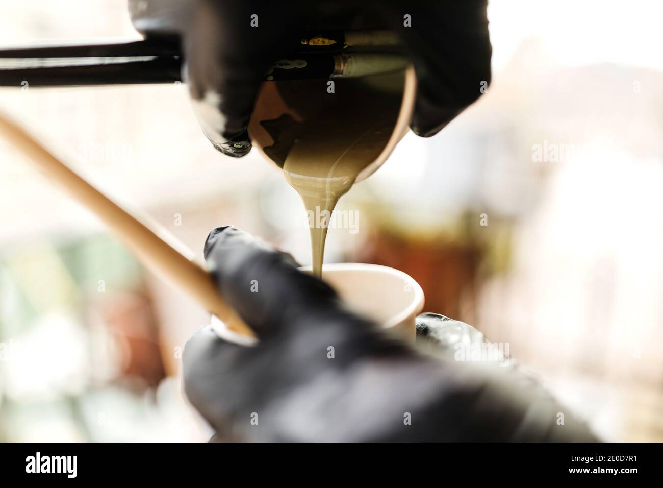 Unrecognizable crop artist pouring paint in cup and mixing different ...