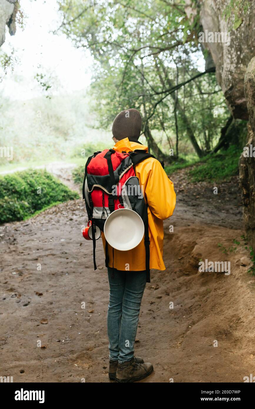 Back view of explorer with backpack standing on trail near Cobijero ...