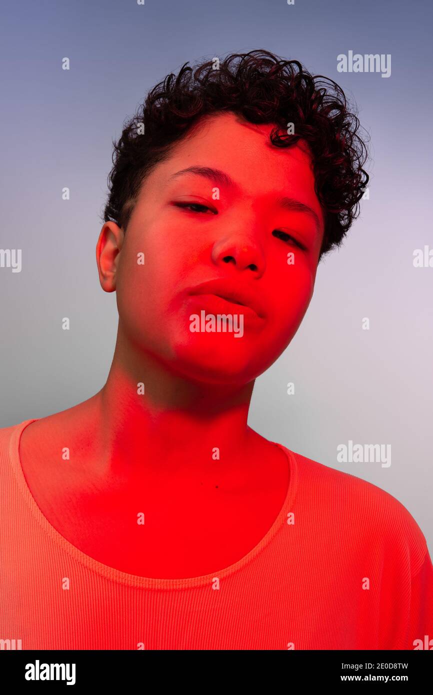 Young challenging Latina Woman with a color red filter. Tinted photo ...