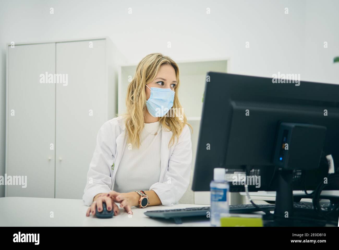 Side view of content female veterinarian in uniform with test tube ...