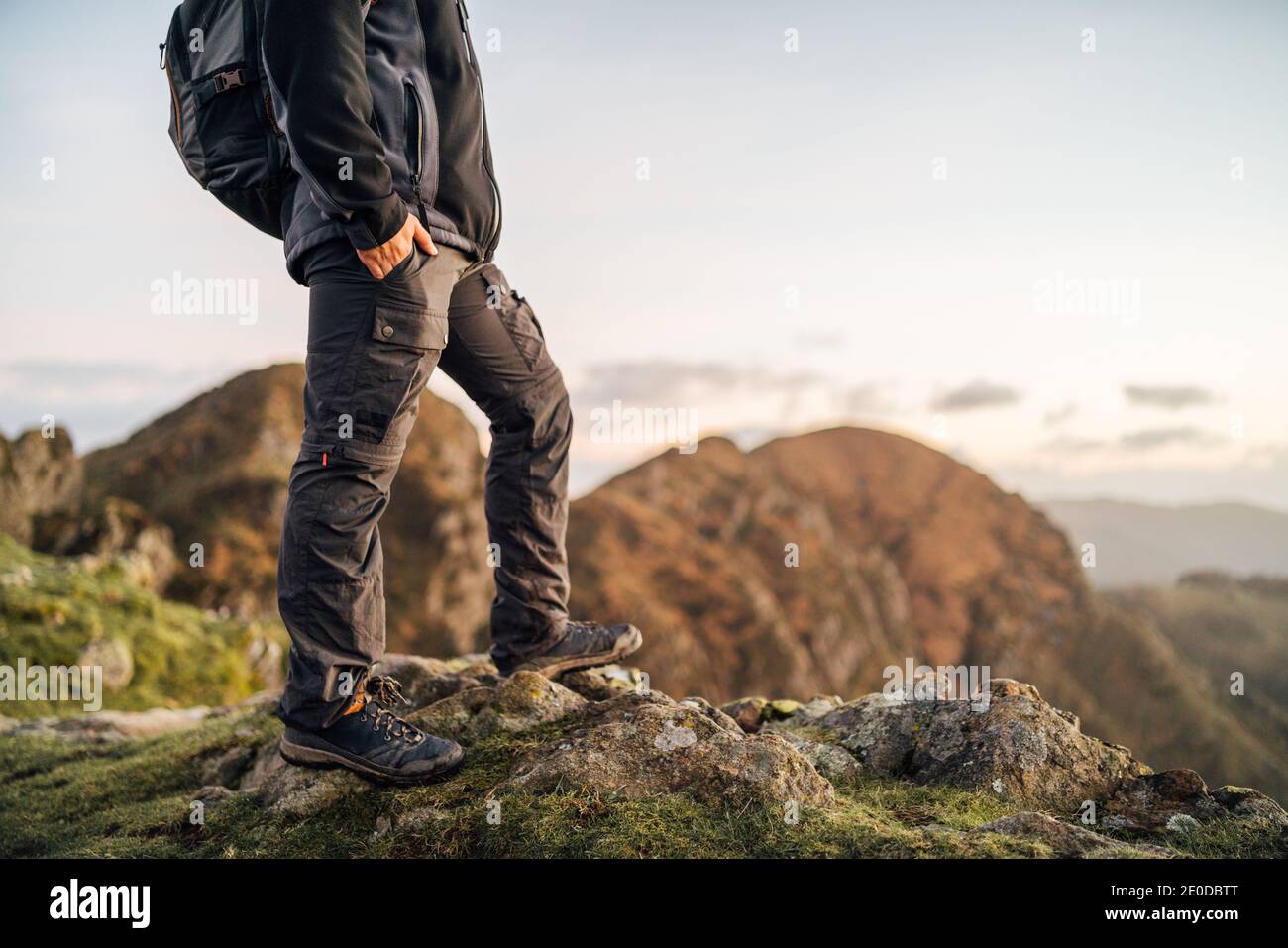 Side view of cropped unrecognizable lonely male explorer with backpack ...