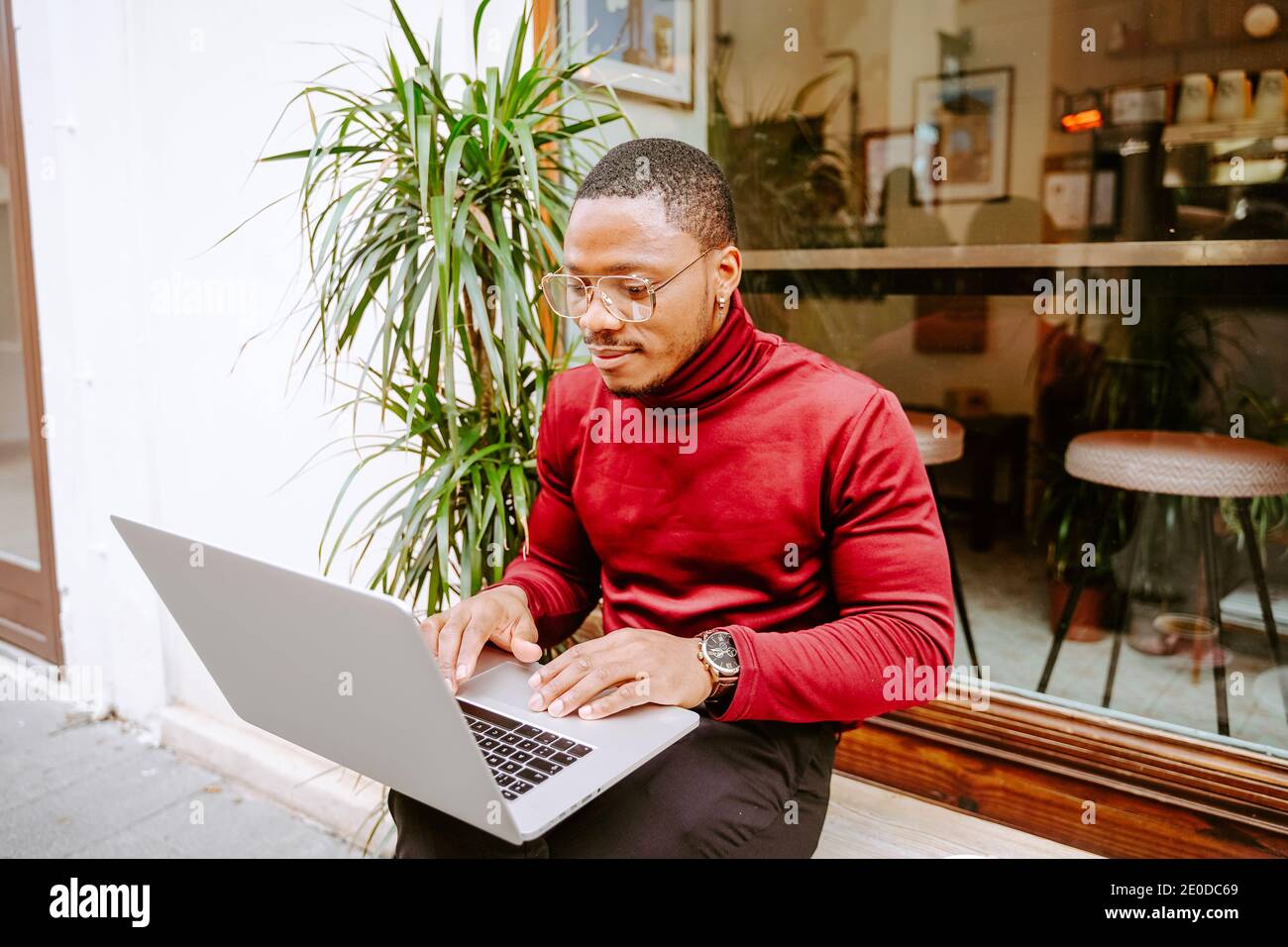 Rich stylish focused African American male entrepreneur sitting on ...