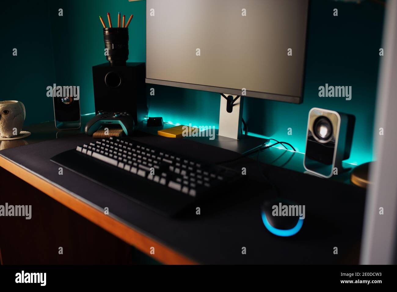 Modern stylish black gaming computer with keyboard and speakers placed ...