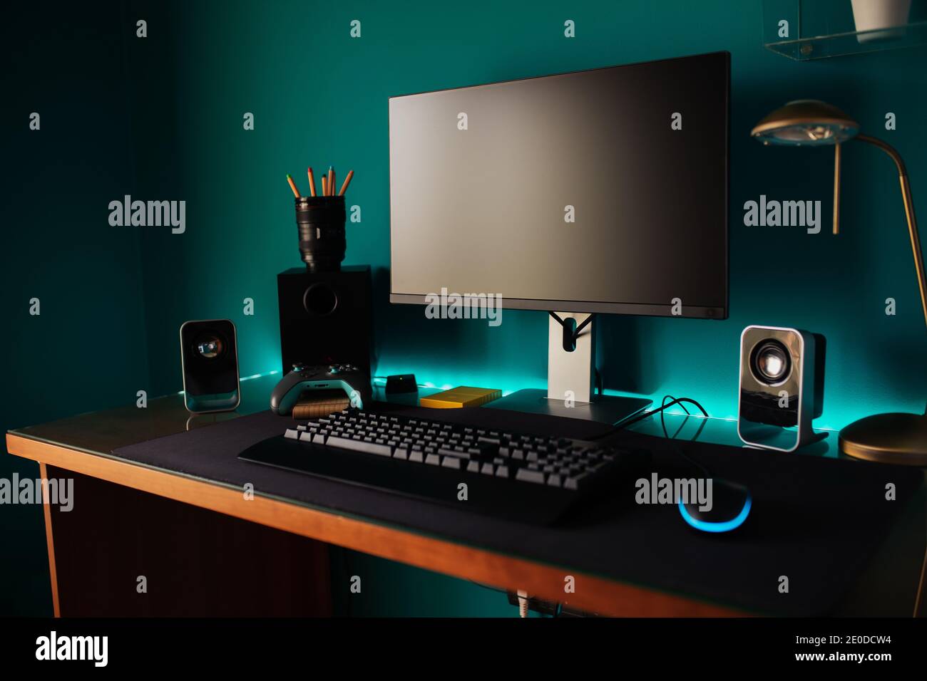 Modern stylish black gaming computer with keyboard and speakers placed ...