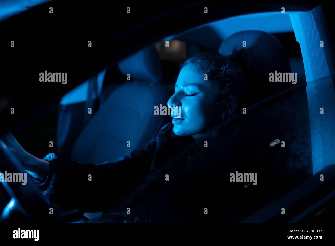 Side view of unhappy young female thinking about problems and crying ...