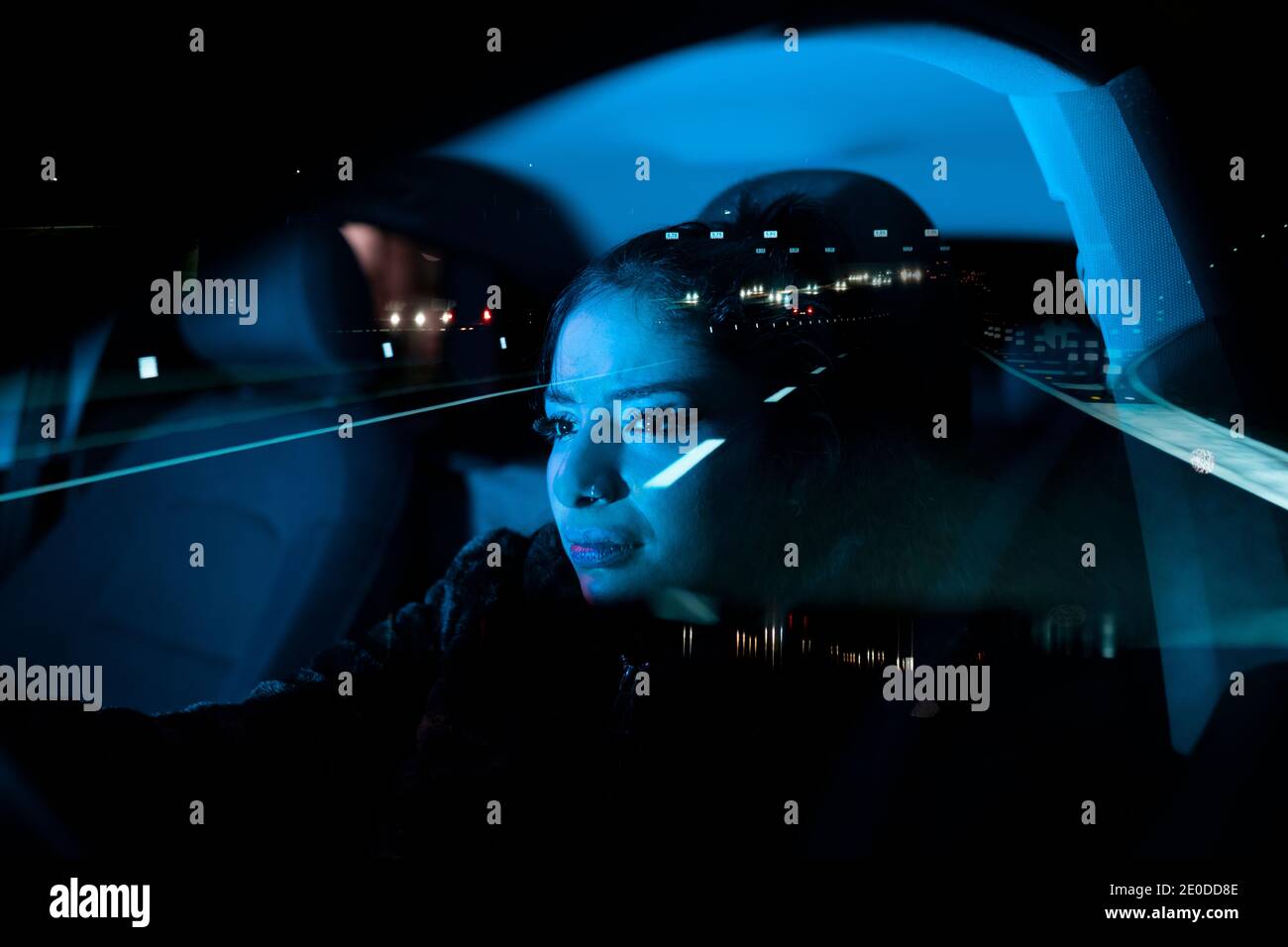 Reflection in windshield of frustrated female driver crying while ...