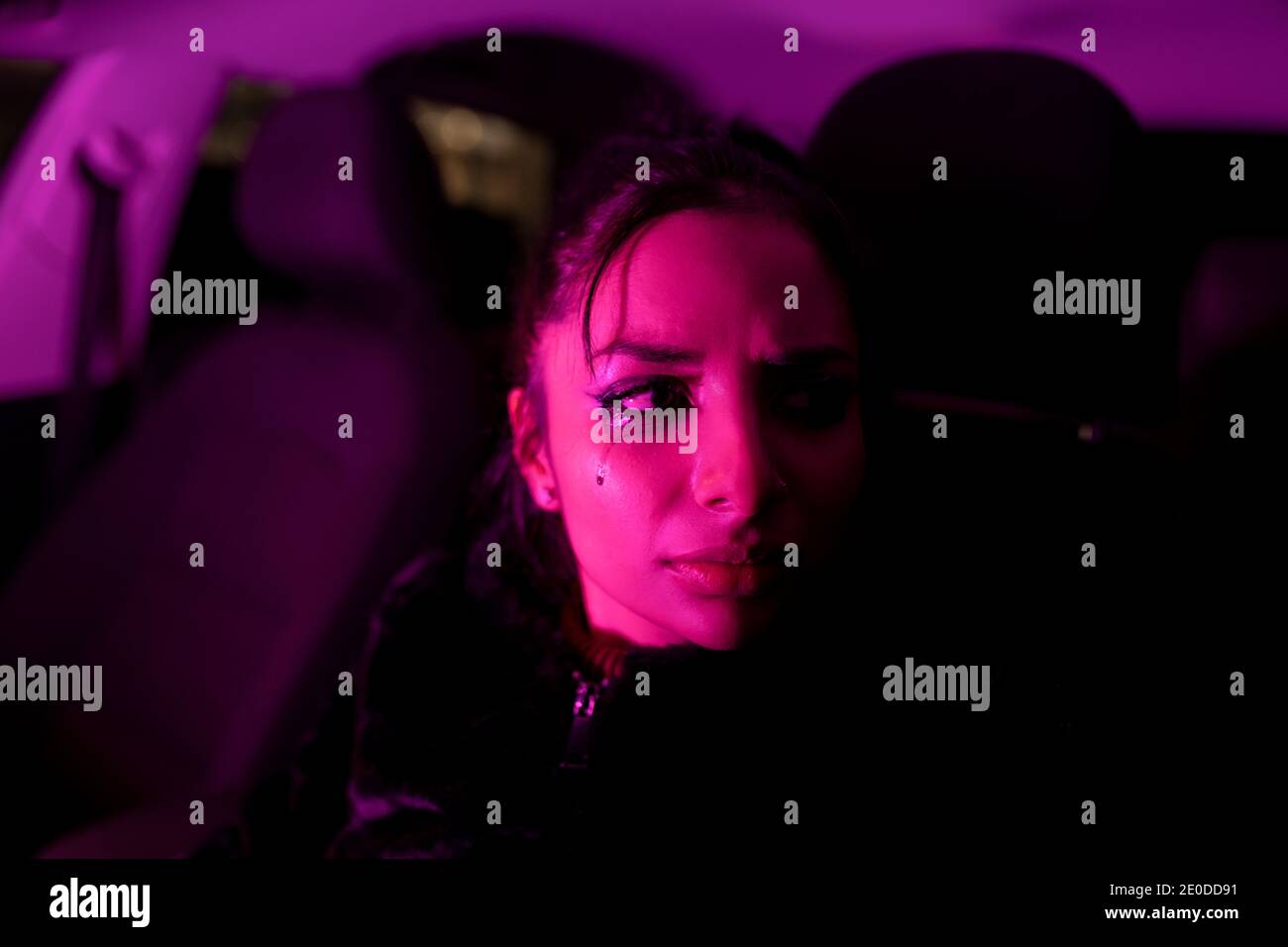 Side view of unhappy young female thinking about problems and crying ...