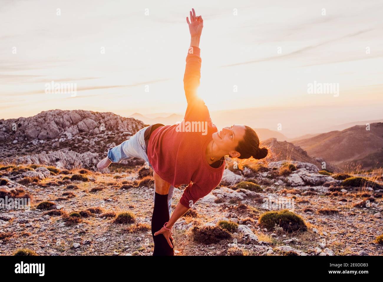 Side view of flexible female in casual clothes performing Lord of the ...