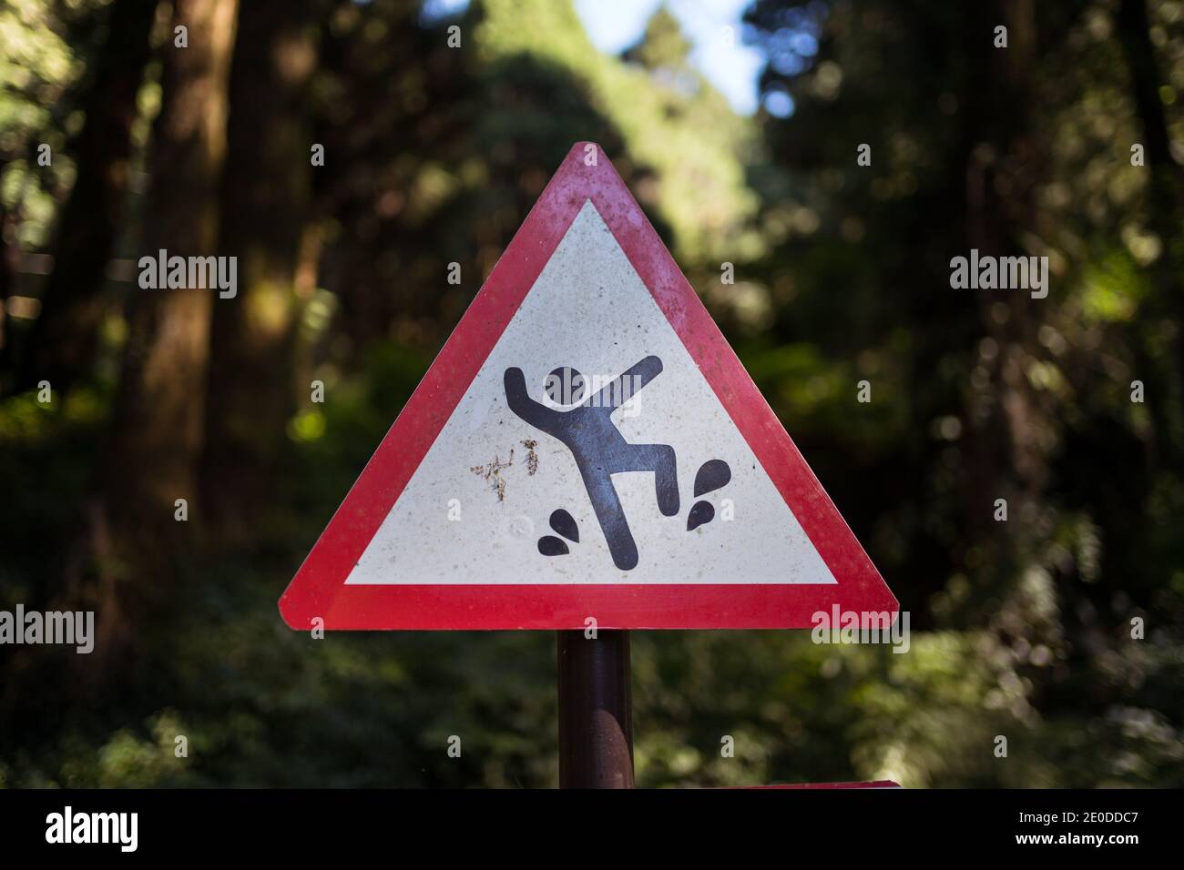 Metal warning road sign in shape of triangle of red and white colors ...
