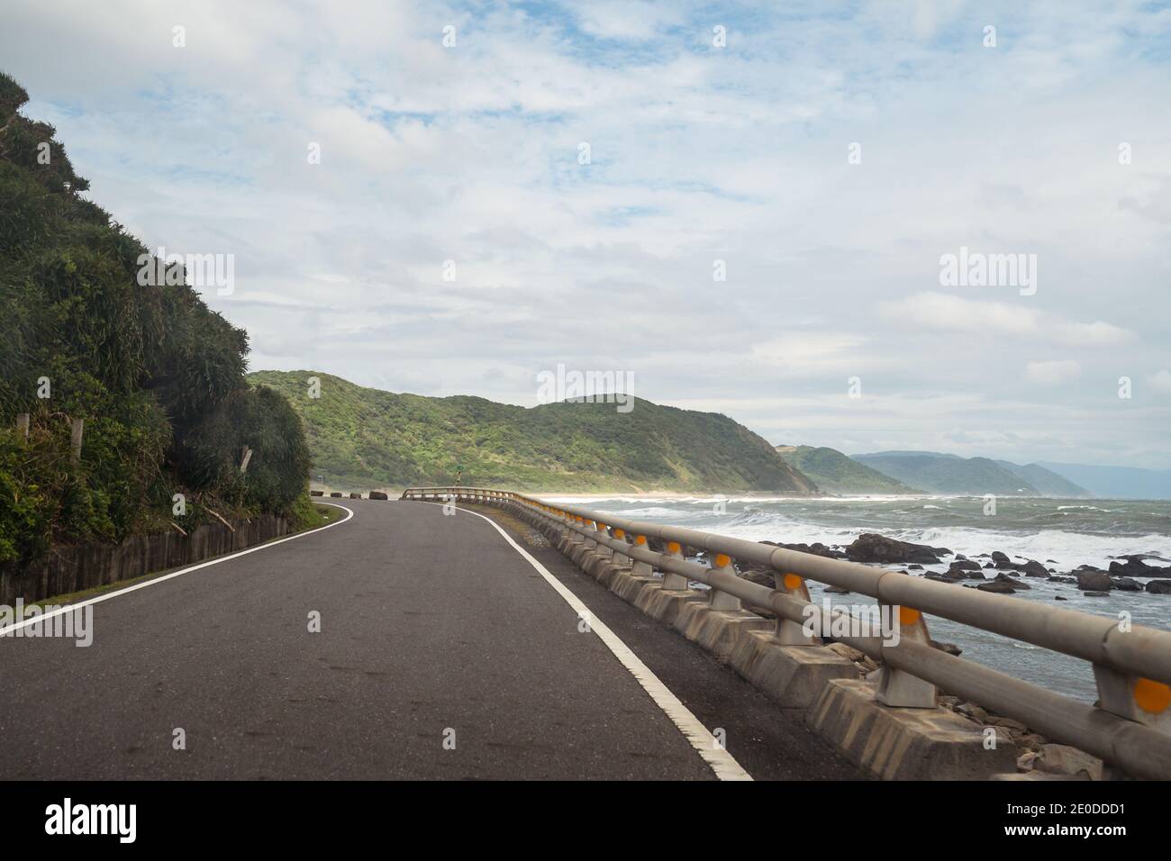 Amazing view of empty asphalt roadway surrounded by waving sea and ...