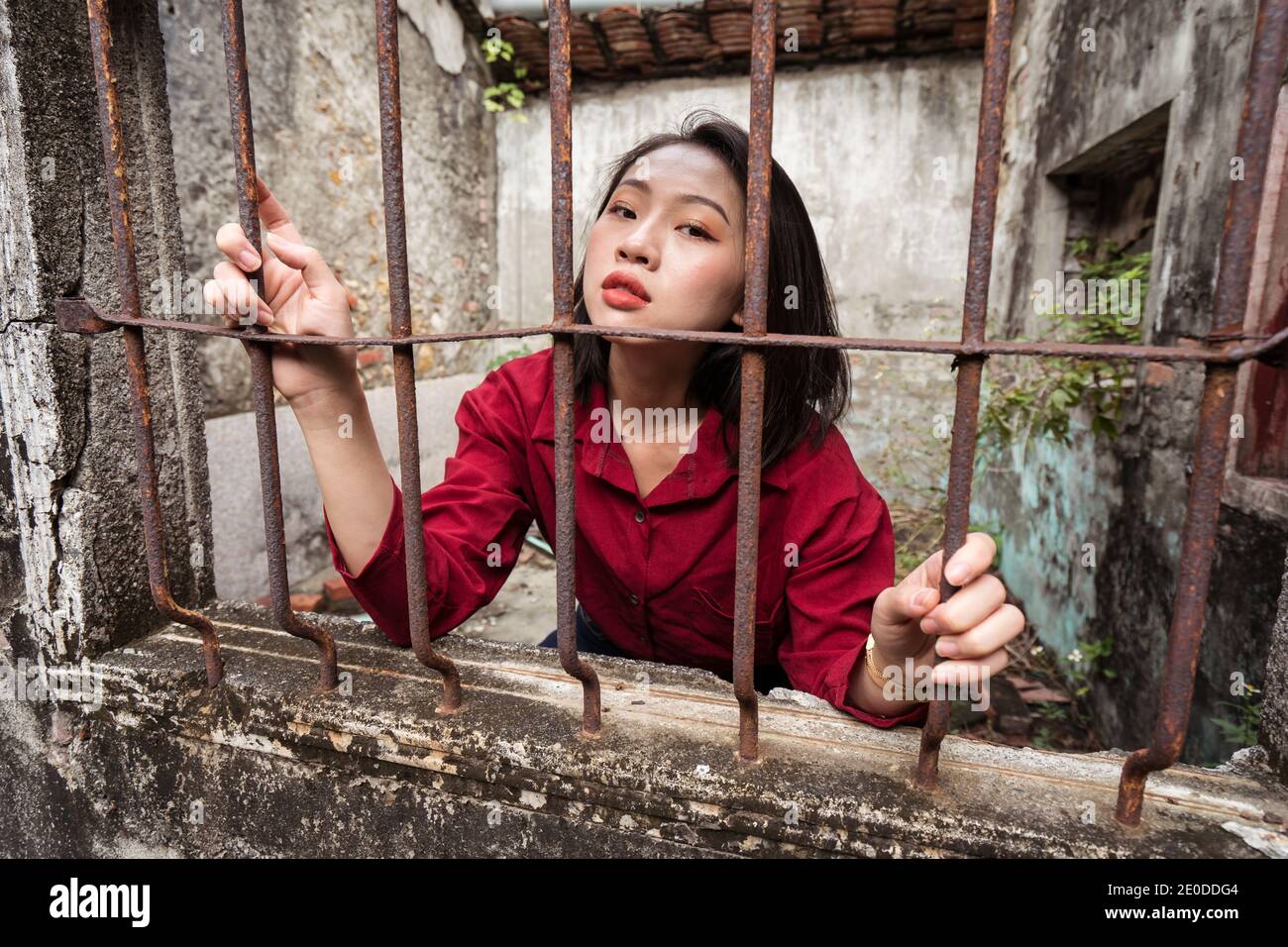 Young Asian female standing inside of abandoned old stone building and ...