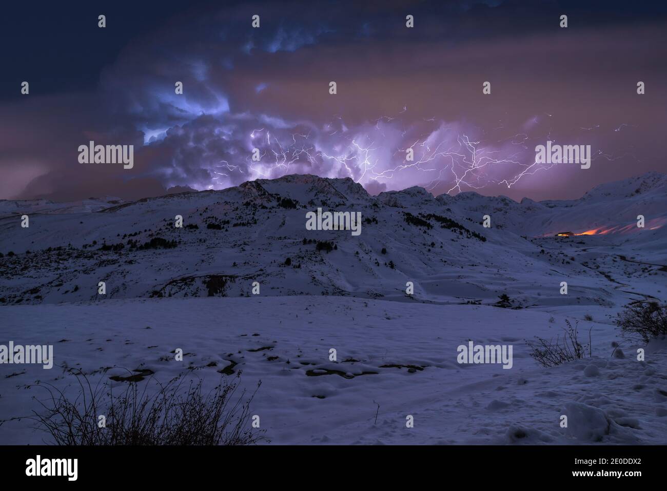 Scenery of mountain range covered with snow under thunderstorm sky with ...