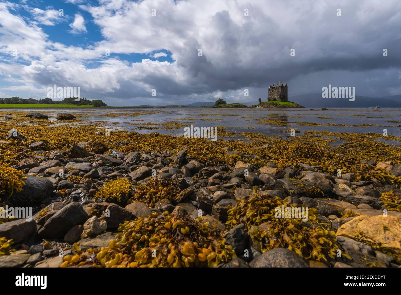 Distant view of magnificent ancient Castle Stalker located near calm ...
