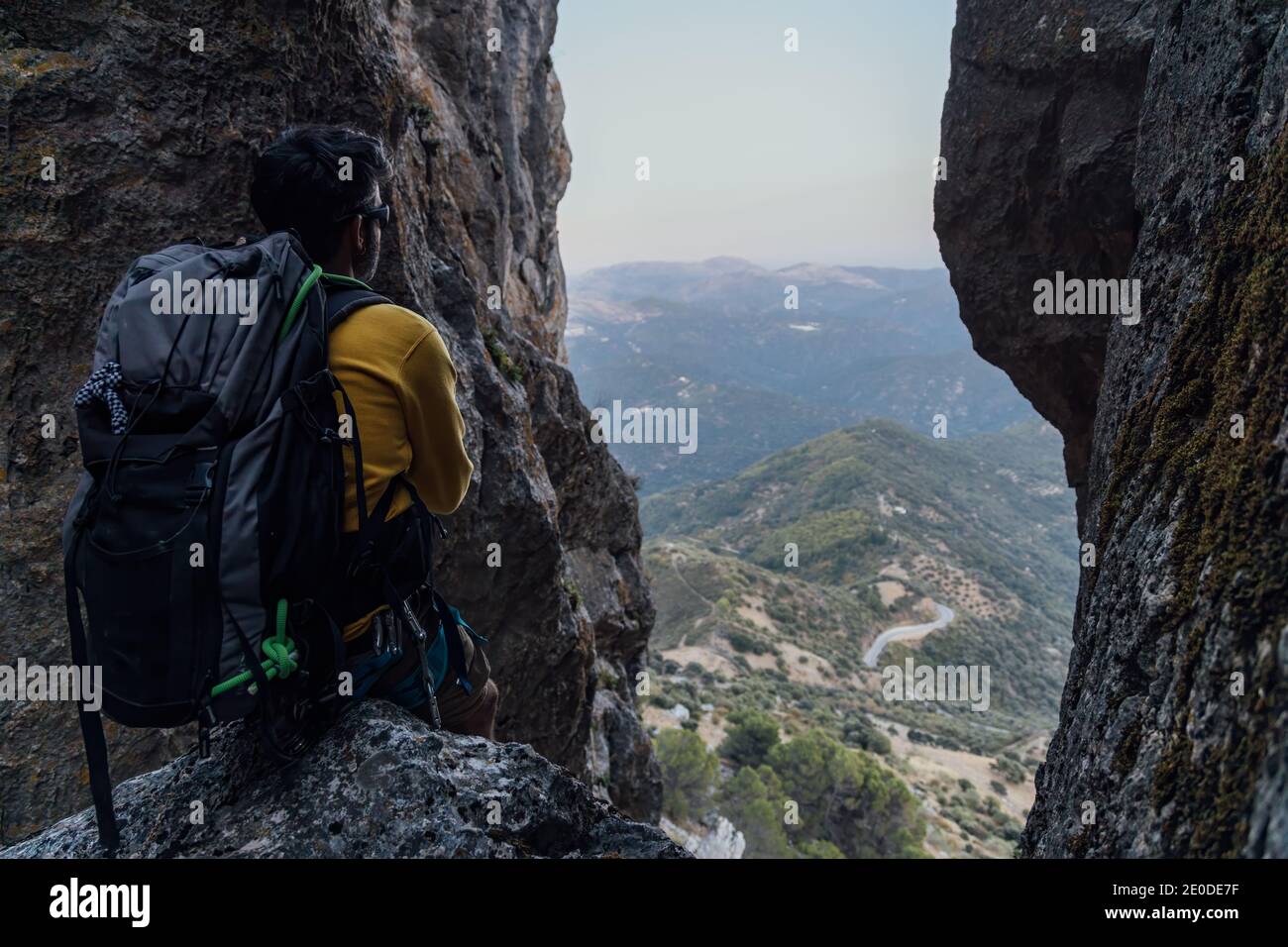 Back view of unrecognizable male explorer with backpack admiring ...