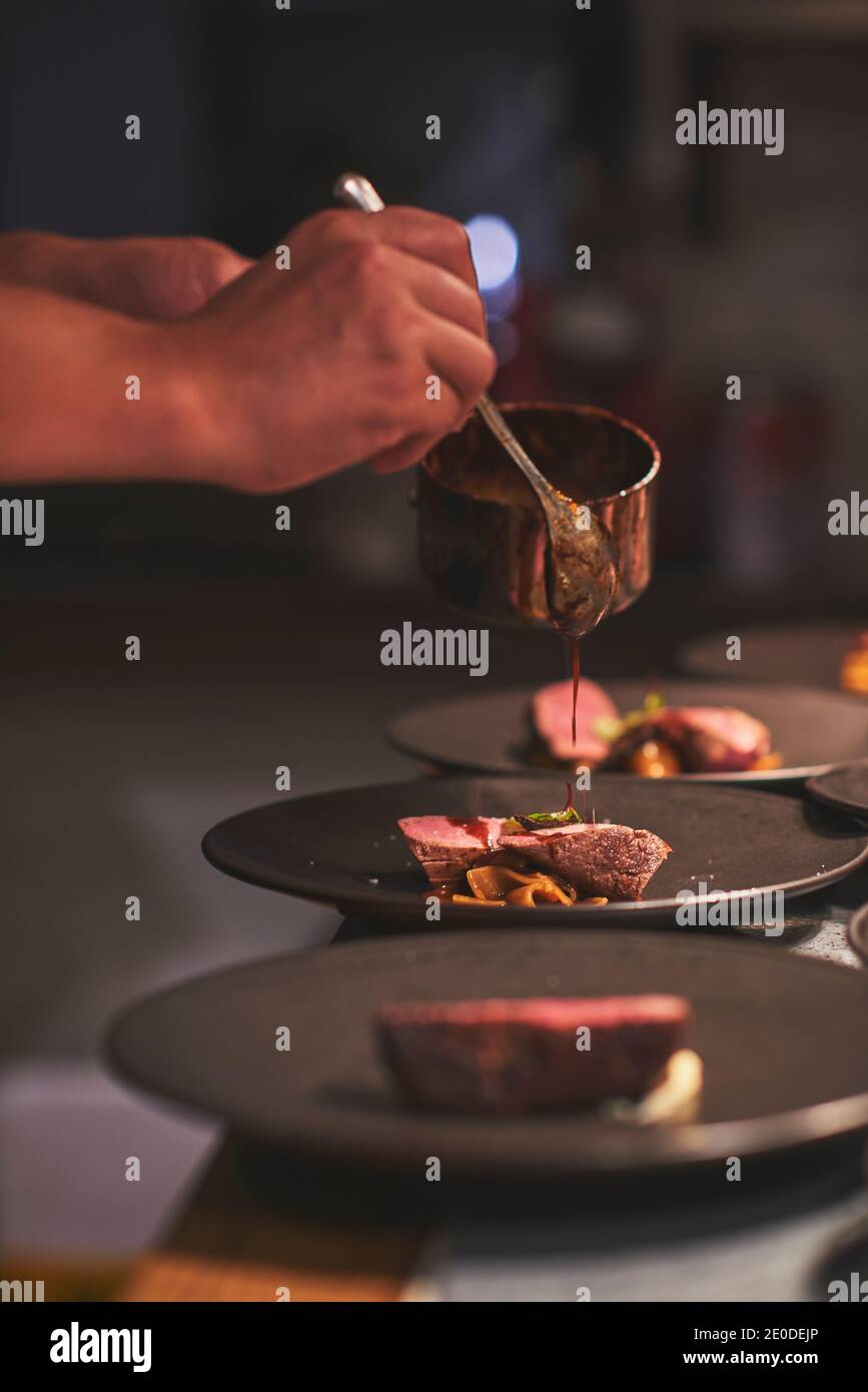 Chefs preparing beautiful dishes in French restaurant's kitchen Stock ...