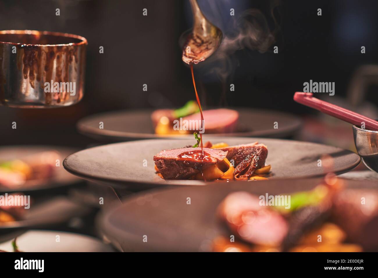Chefs preparing beautiful dishes in French restaurant's kitchen Stock ...