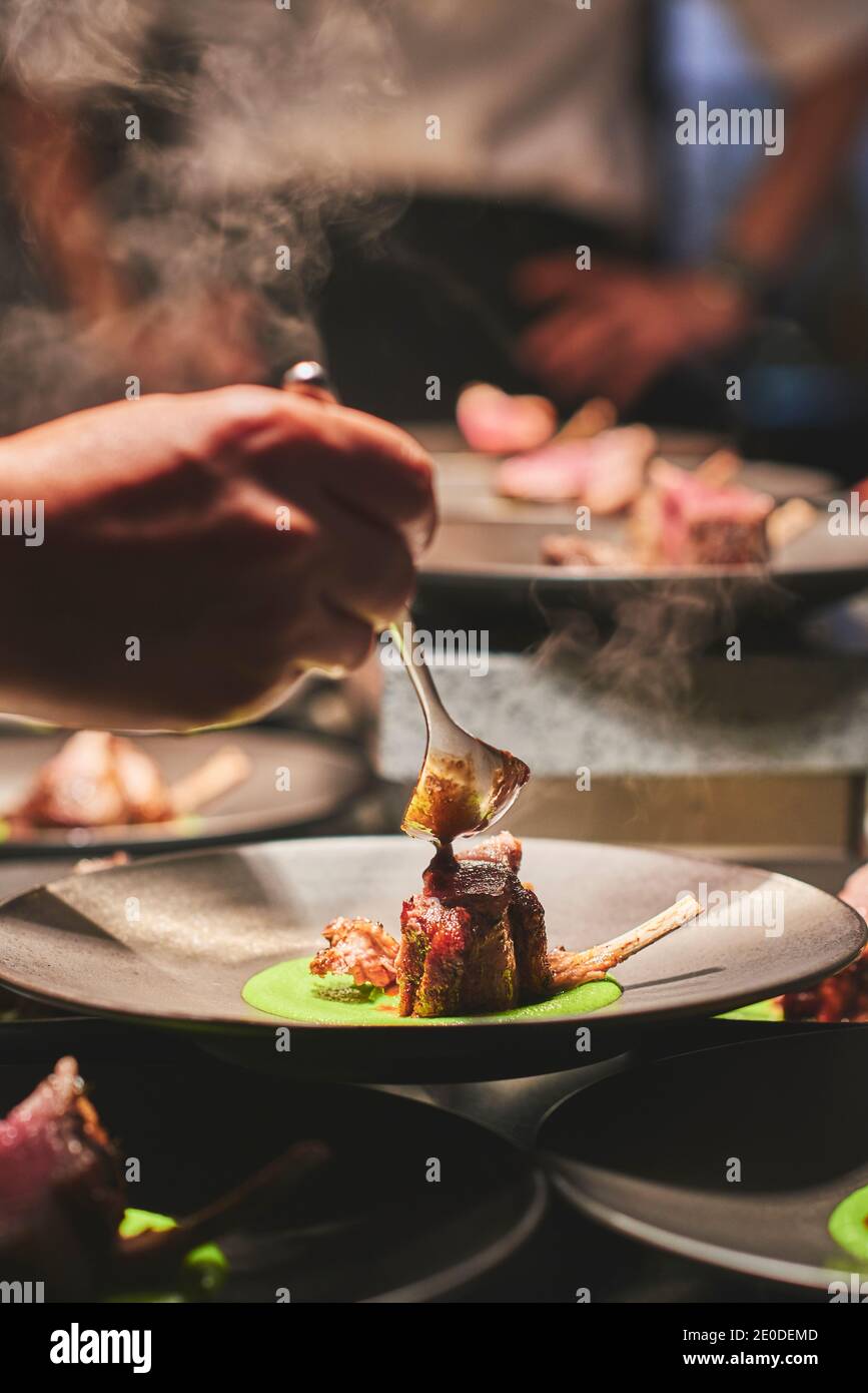 Chefs preparing beautiful dishes in French restaurant's kitchen Stock ...