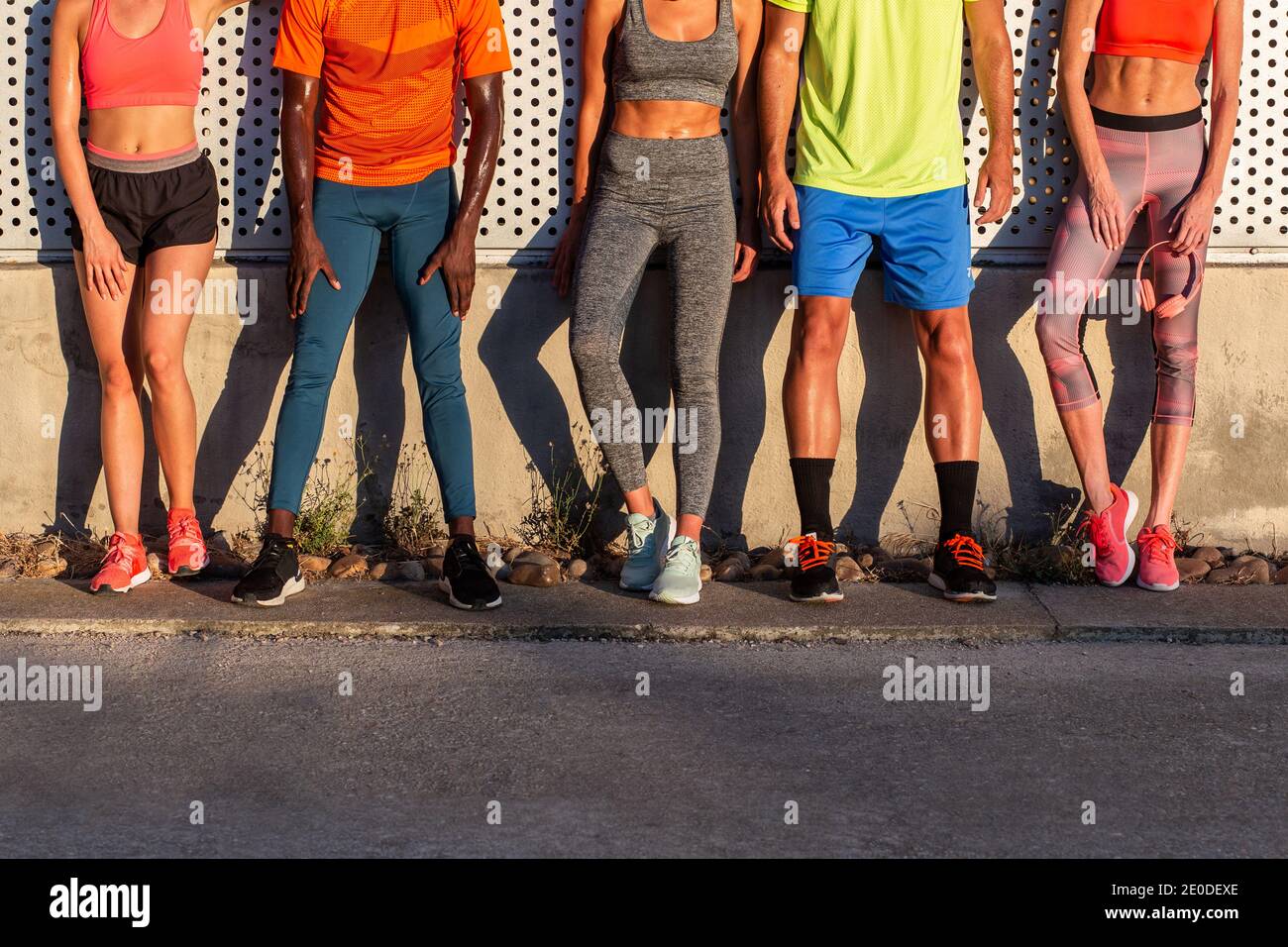 Group of crop unrecognizable multiethnic fit runners in sportswear ...