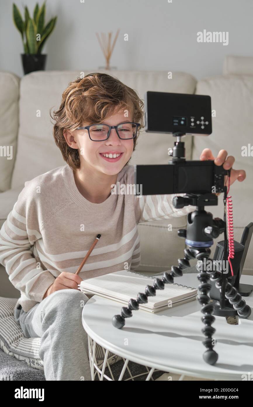 Happy young boy filming video at home with modern equipment Stock Photo ...