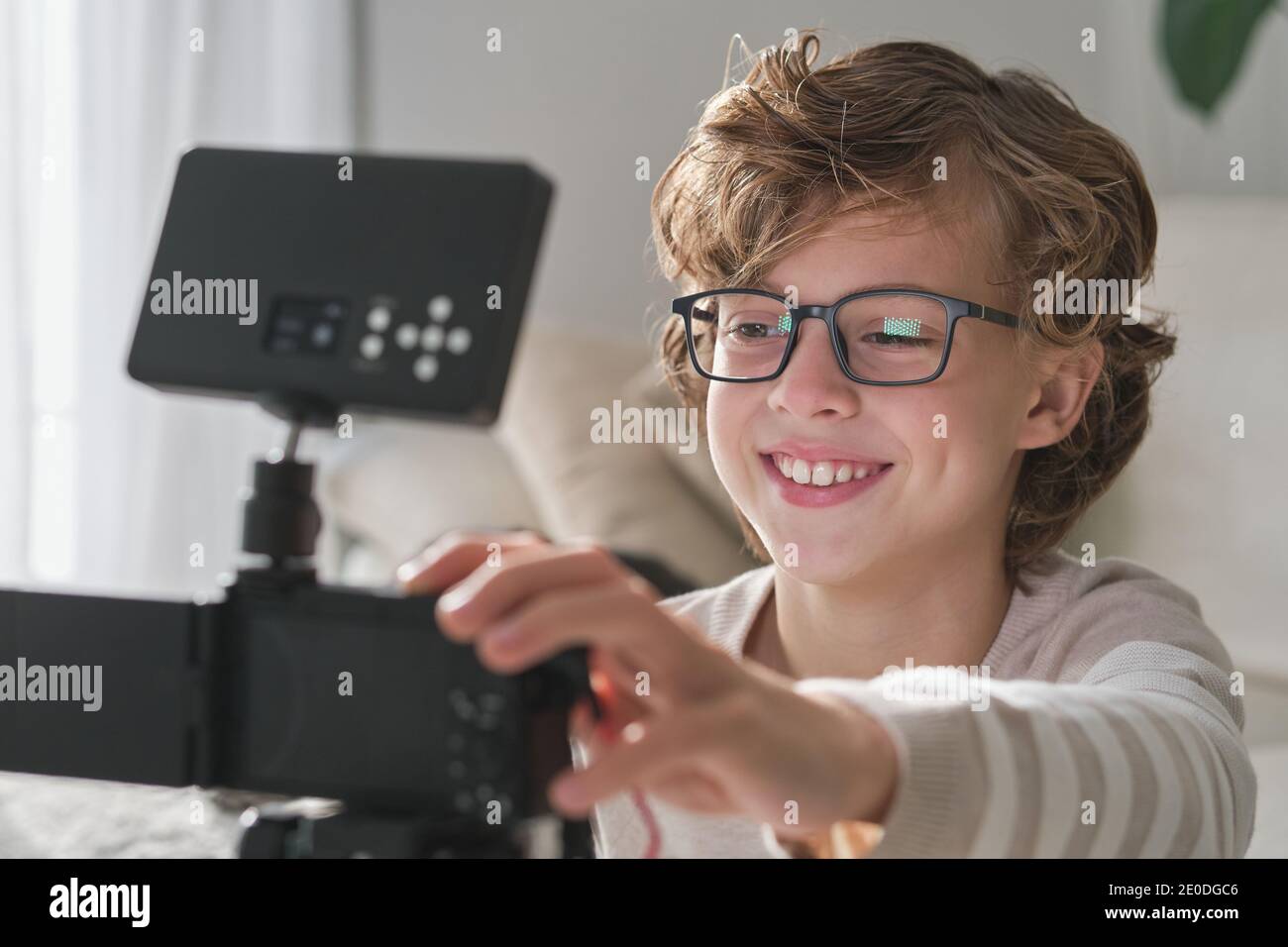 Happy young boy filming video at home with modern equipment Stock Photo ...