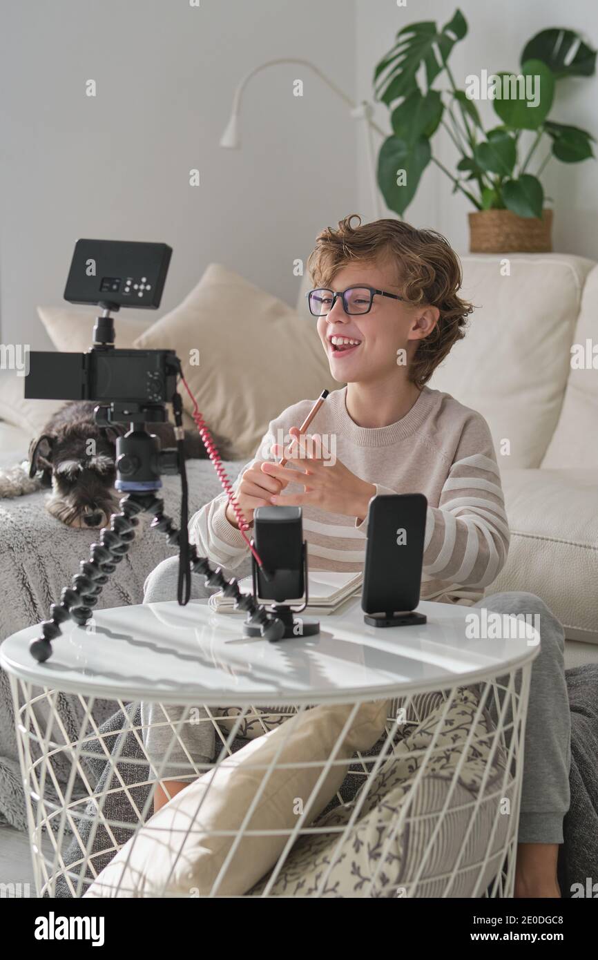 Happy young boy filming video at home with modern equipment Stock Photo ...