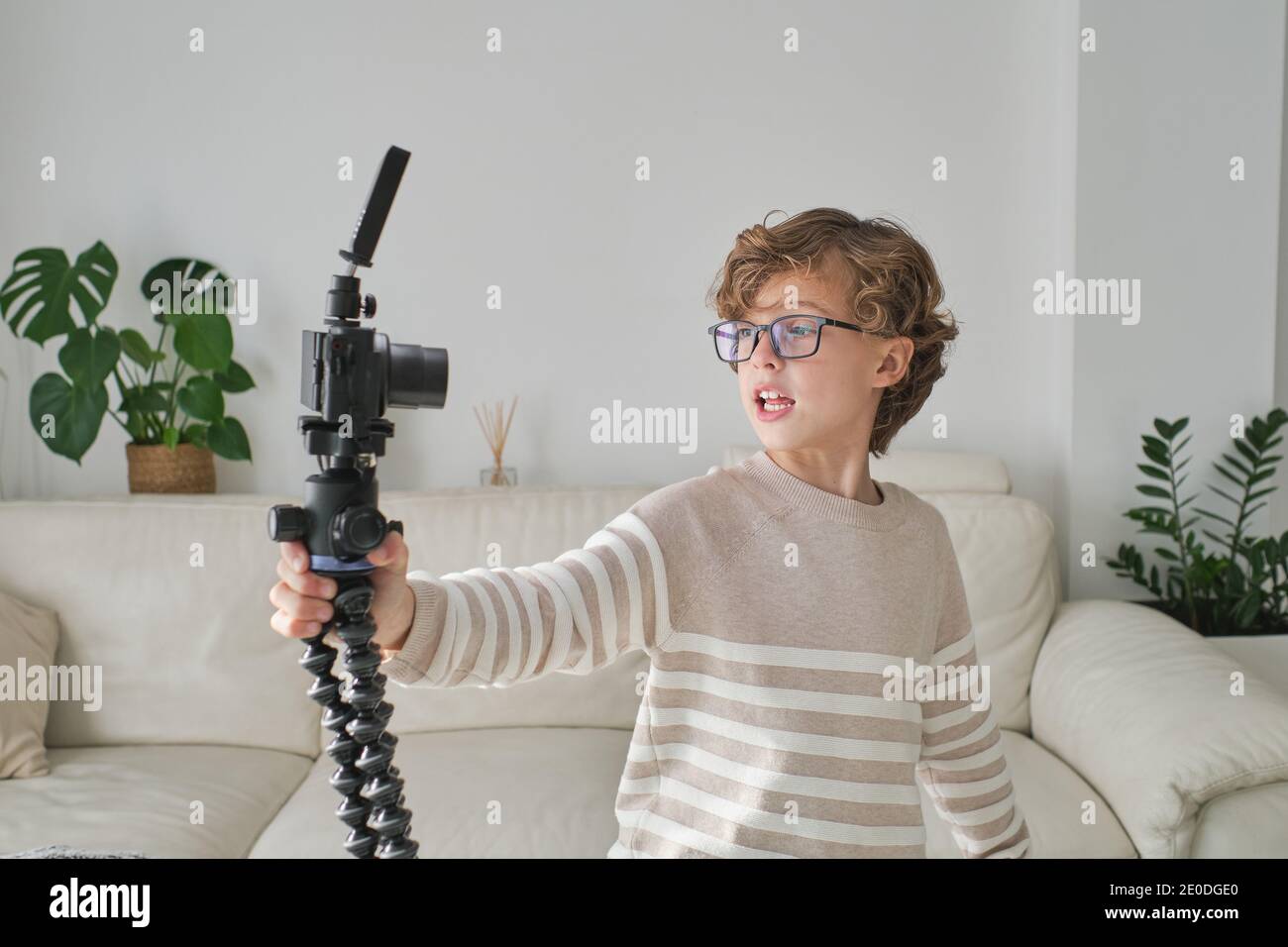Young boy making video in his house for his channel Stock Photo - Alamy
