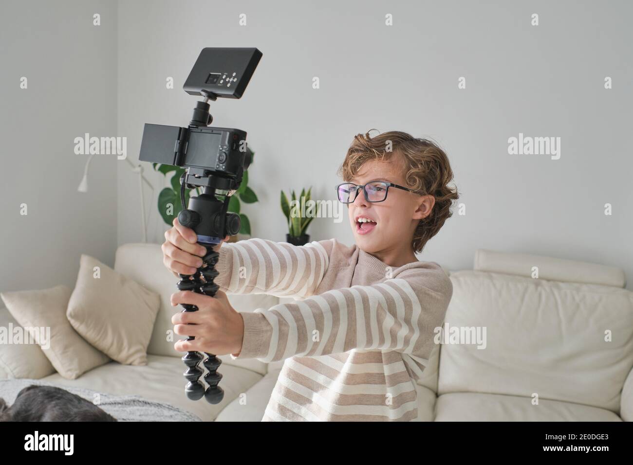 Young boy making video in his house for his channel Stock Photo - Alamy