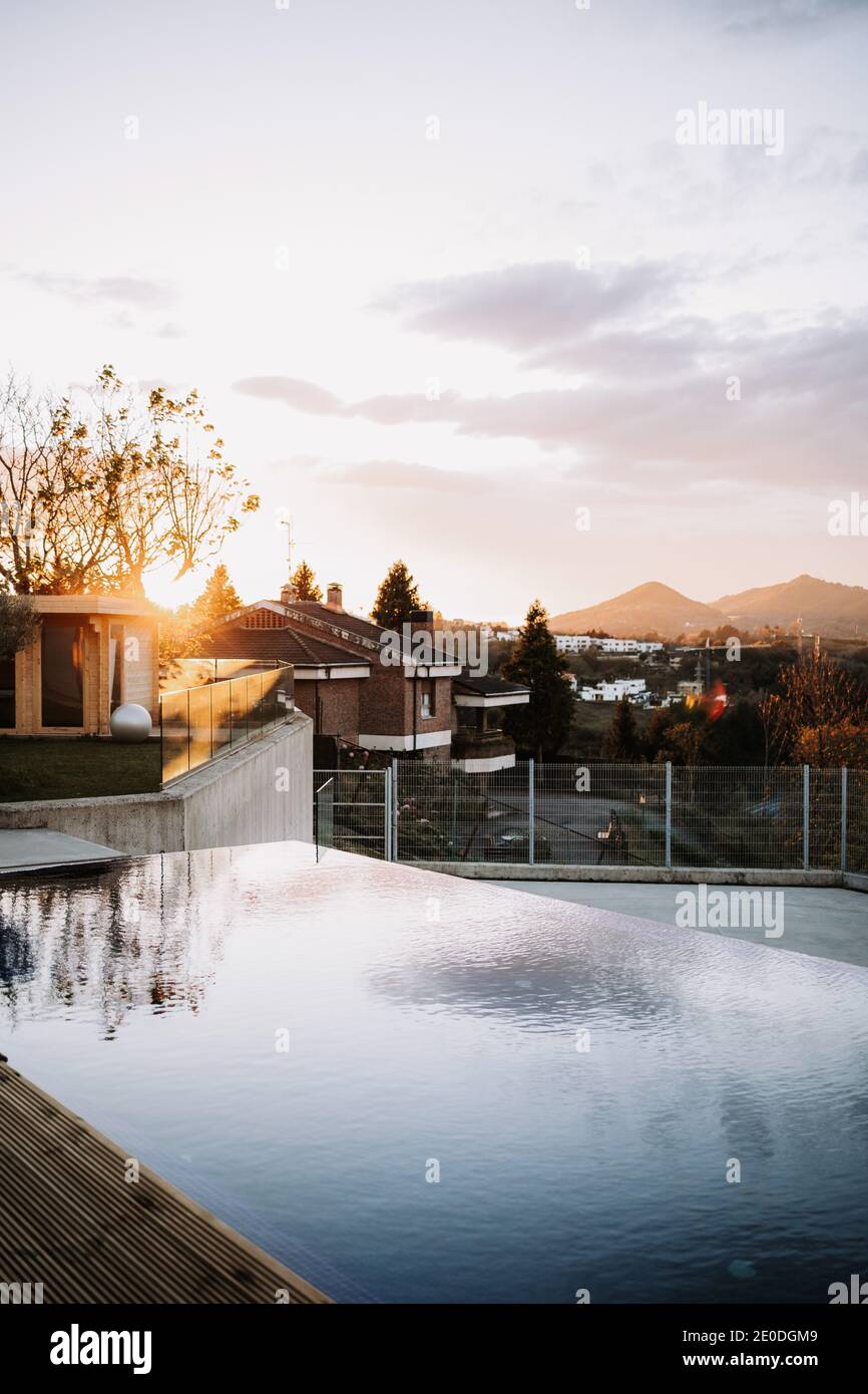 Swimming pool with rippling water located in courtyard of contemporary ...