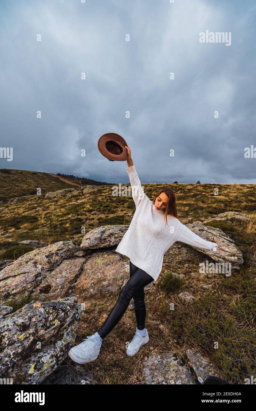Back view full body content female standing on hilly seafront and ...