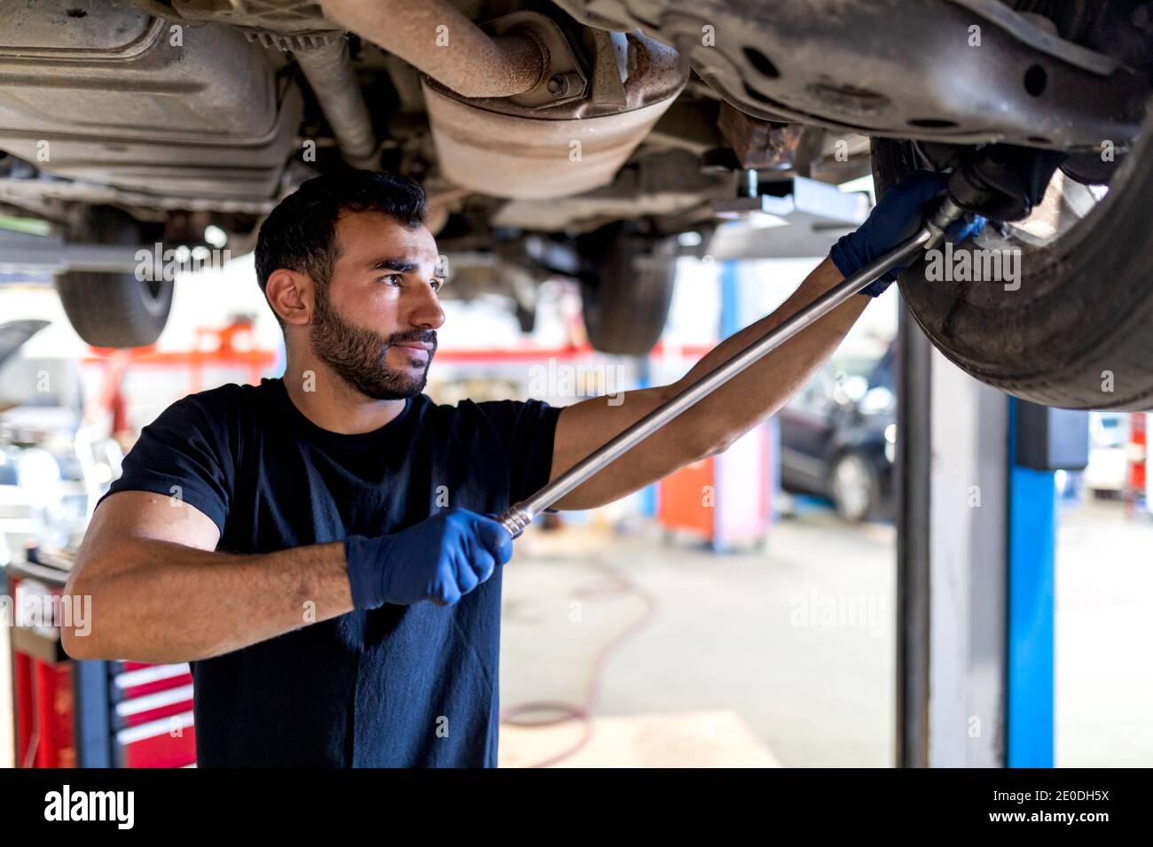 Male Mechanic Under Car
