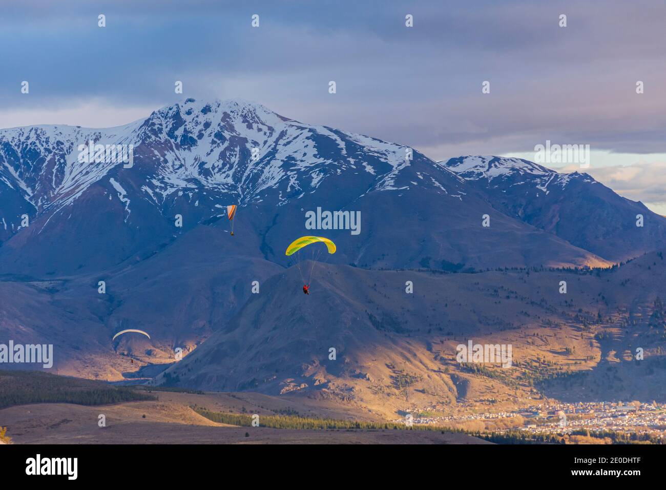 Paragliders against snow-capped Andes mountains during winter season in ...