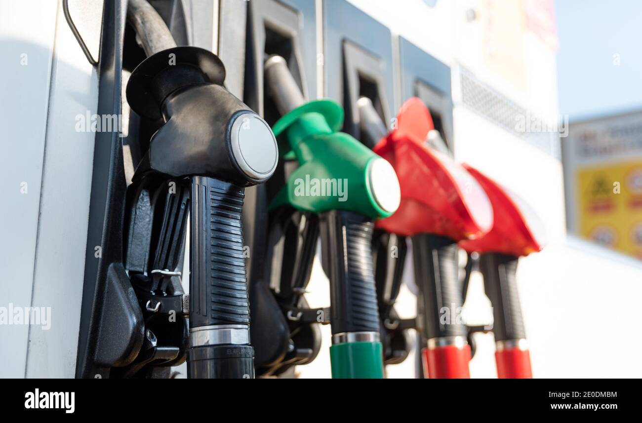 Petrol pump filling nozzles. Fuel at gas station close up Stock Photo ...