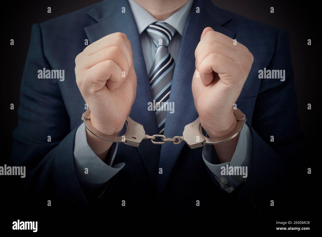 Businessman arrested for corruption. Man in a suit with handcuffs on ...