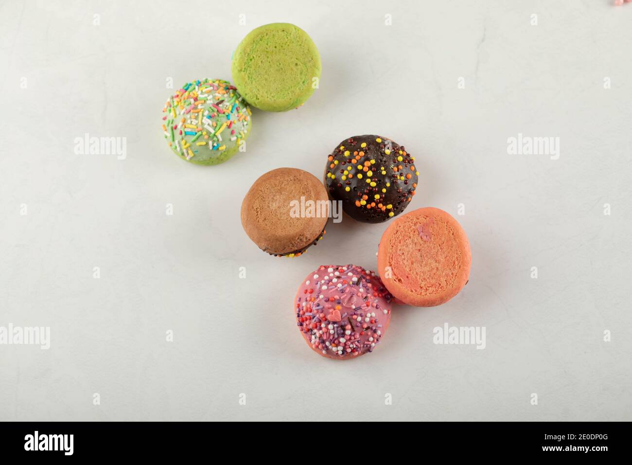 Colorful sweet small doughnuts on a white background Stock Photo - Alamy
