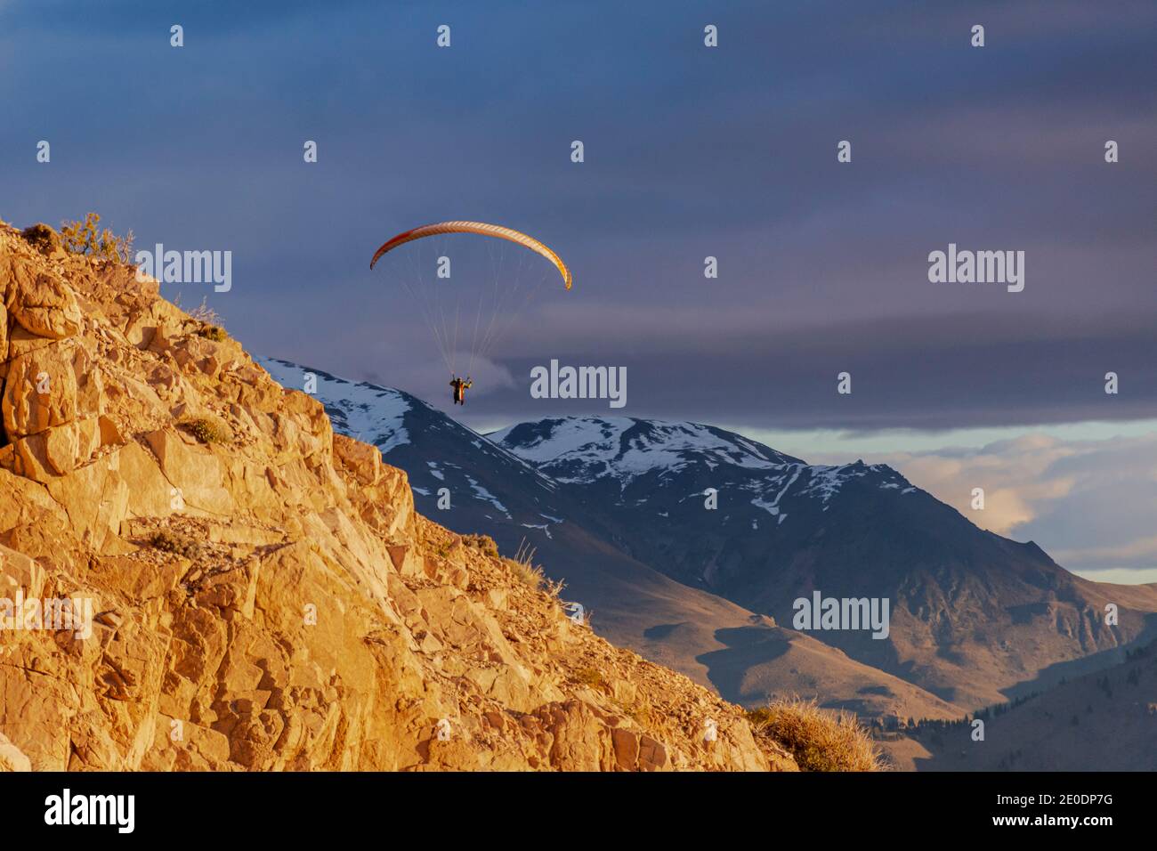 Paragliding against snow-capped Andes mountains during winter season in ...