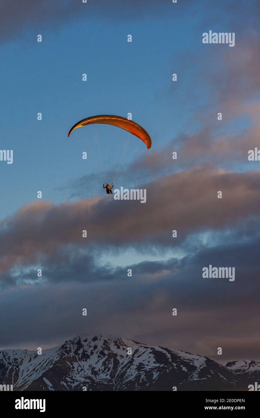 Paragliding against snow-capped Andes mountains during winter season in ...