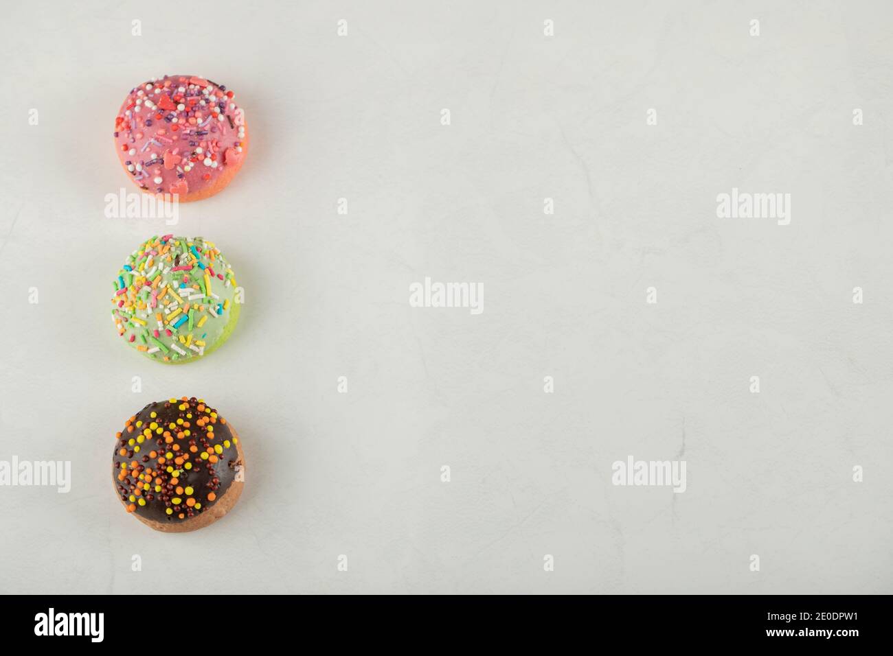 Colorful sweet small doughnuts on a white background Stock Photo - Alamy