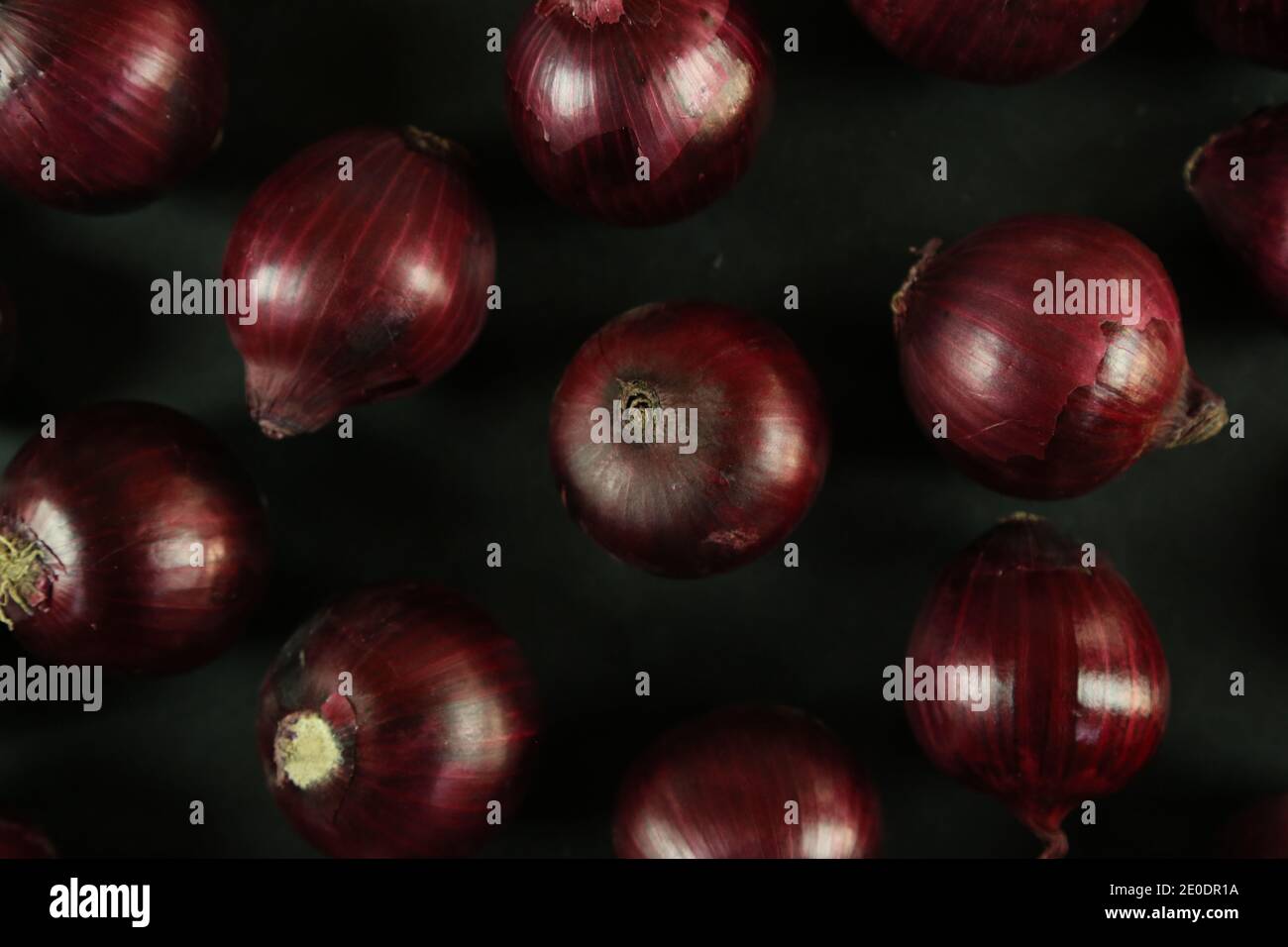 sweet red onions on background Stock Photo - Alamy