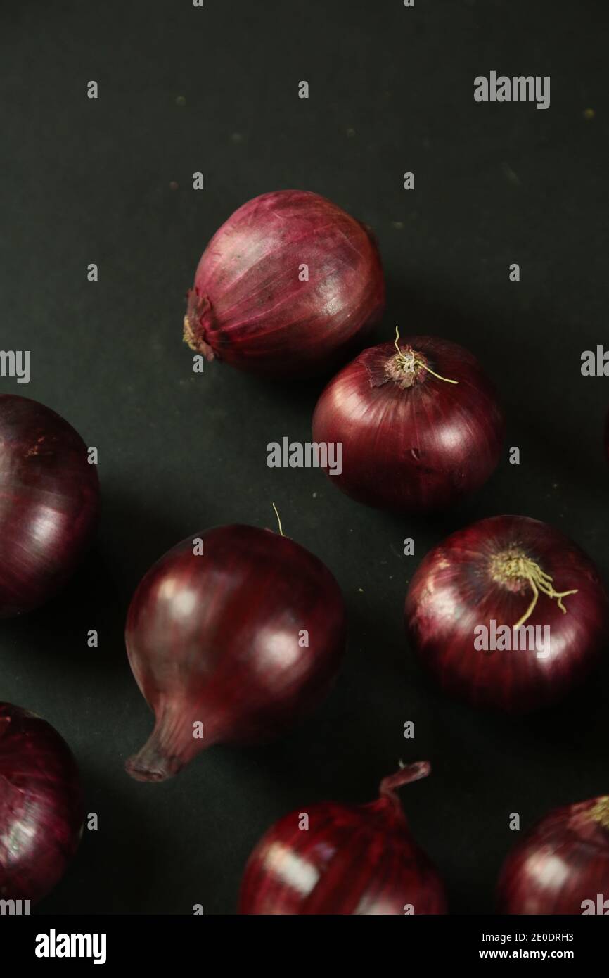 sweet red onions on background Stock Photo - Alamy