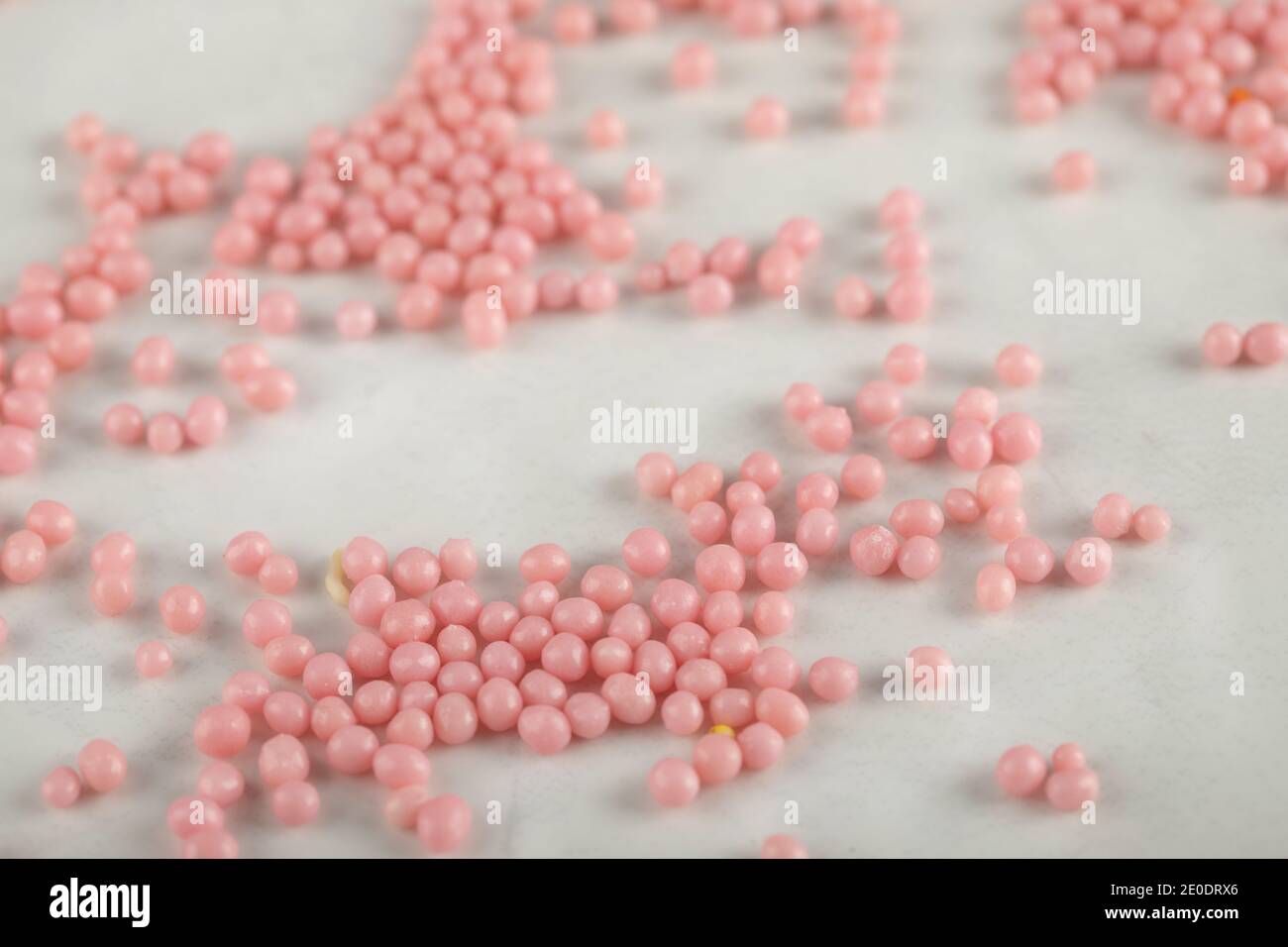 Pink sprinkles on a stone background Stock Photo - Alamy