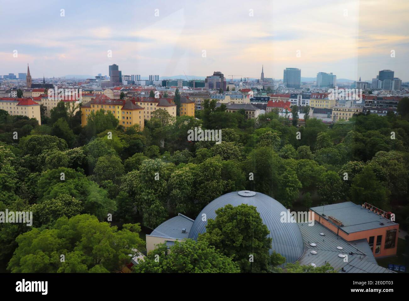 Aerial view of buildings and trees in Vienna, Austria through a window ...