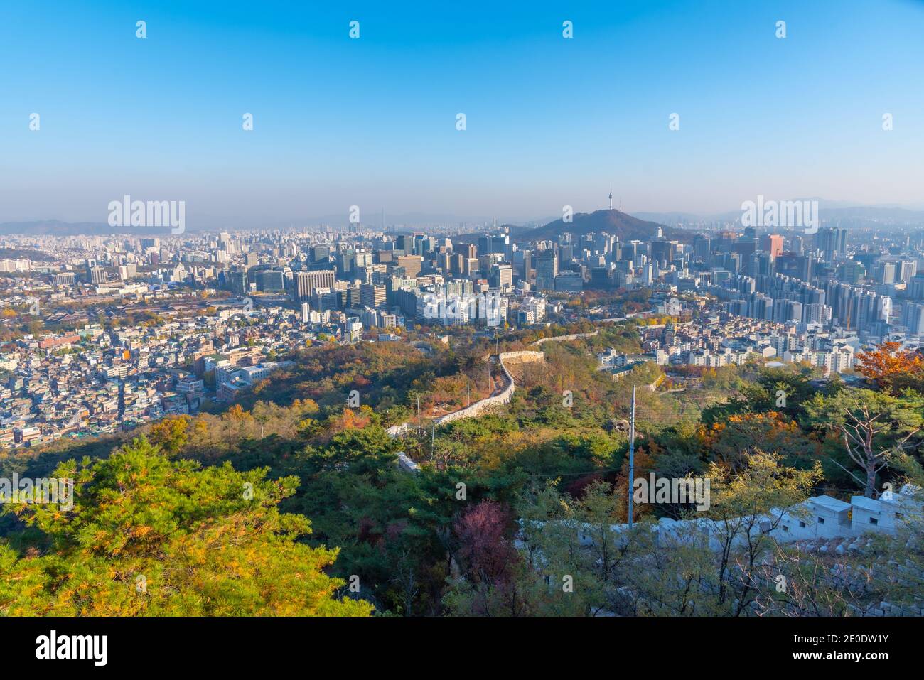 Sunset view of Namsan tower viewed behind an ancient wall at Inwangsan ...