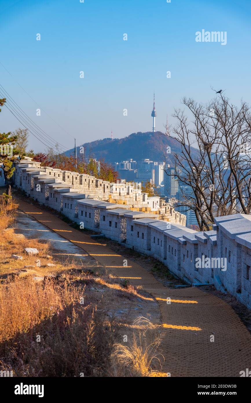 Sunset view of Namsan tower viewed behind an ancient wall at Inwangsan ...