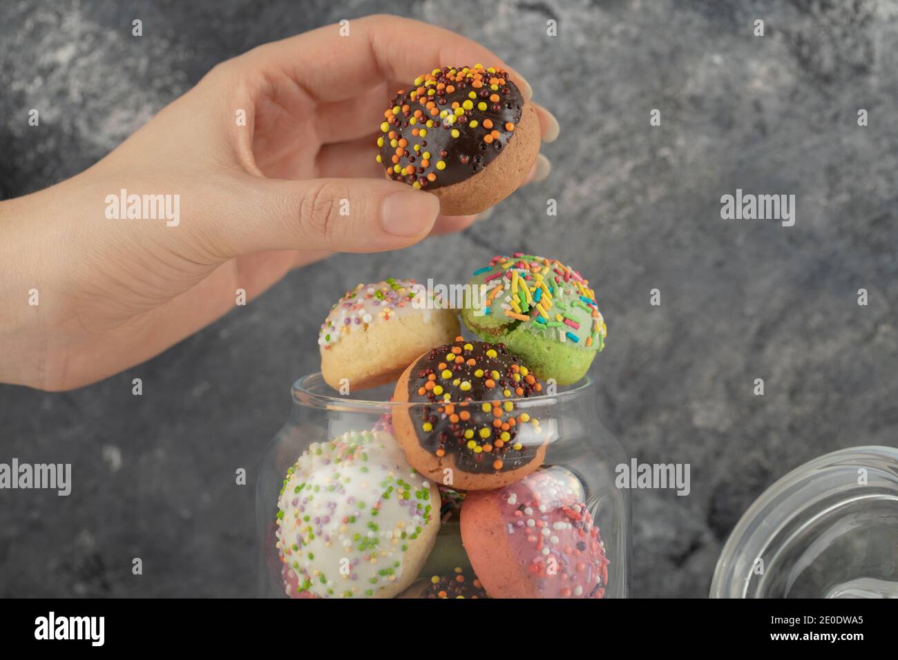 Hand holding donut hi-res stock photography and images - Alamy