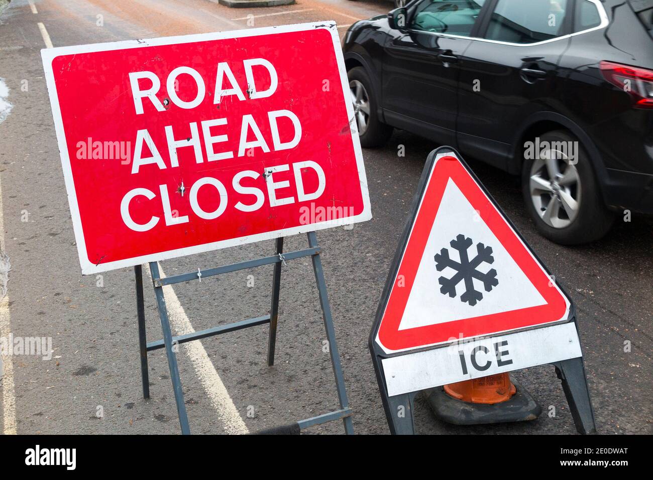 Road ahead closed, snowflake sign, & rock salt fresh grit / freshly ...