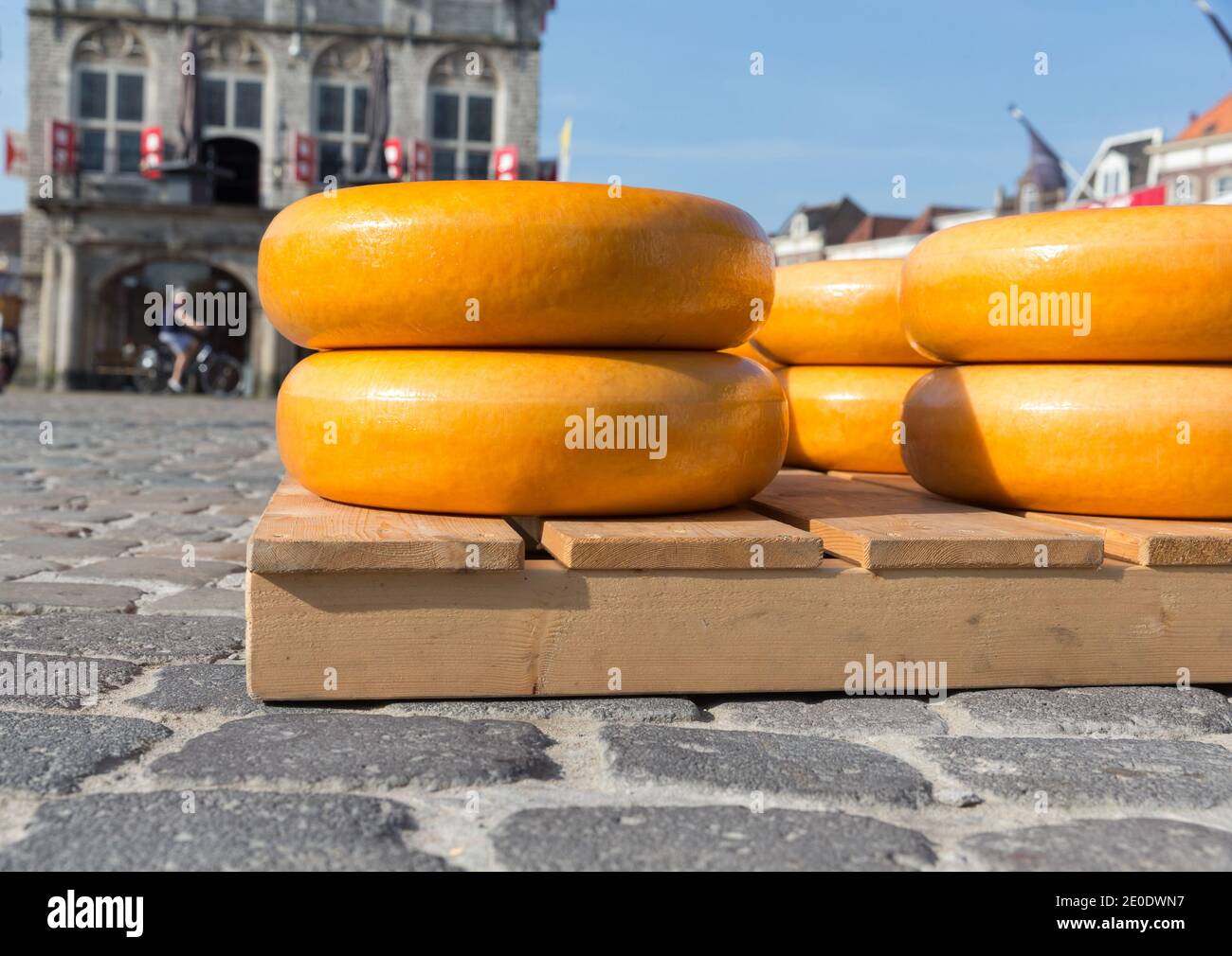 Gouda Cheese is placed in small stacks in front of the historic Town ...