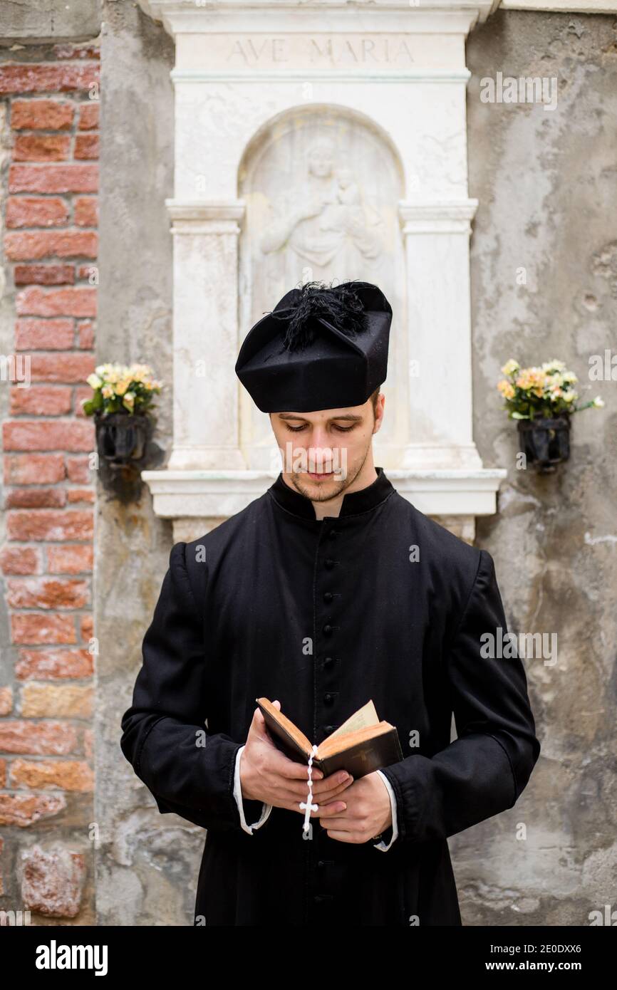 Young priest holding crucifix hi-res stock photography and images - Alamy
